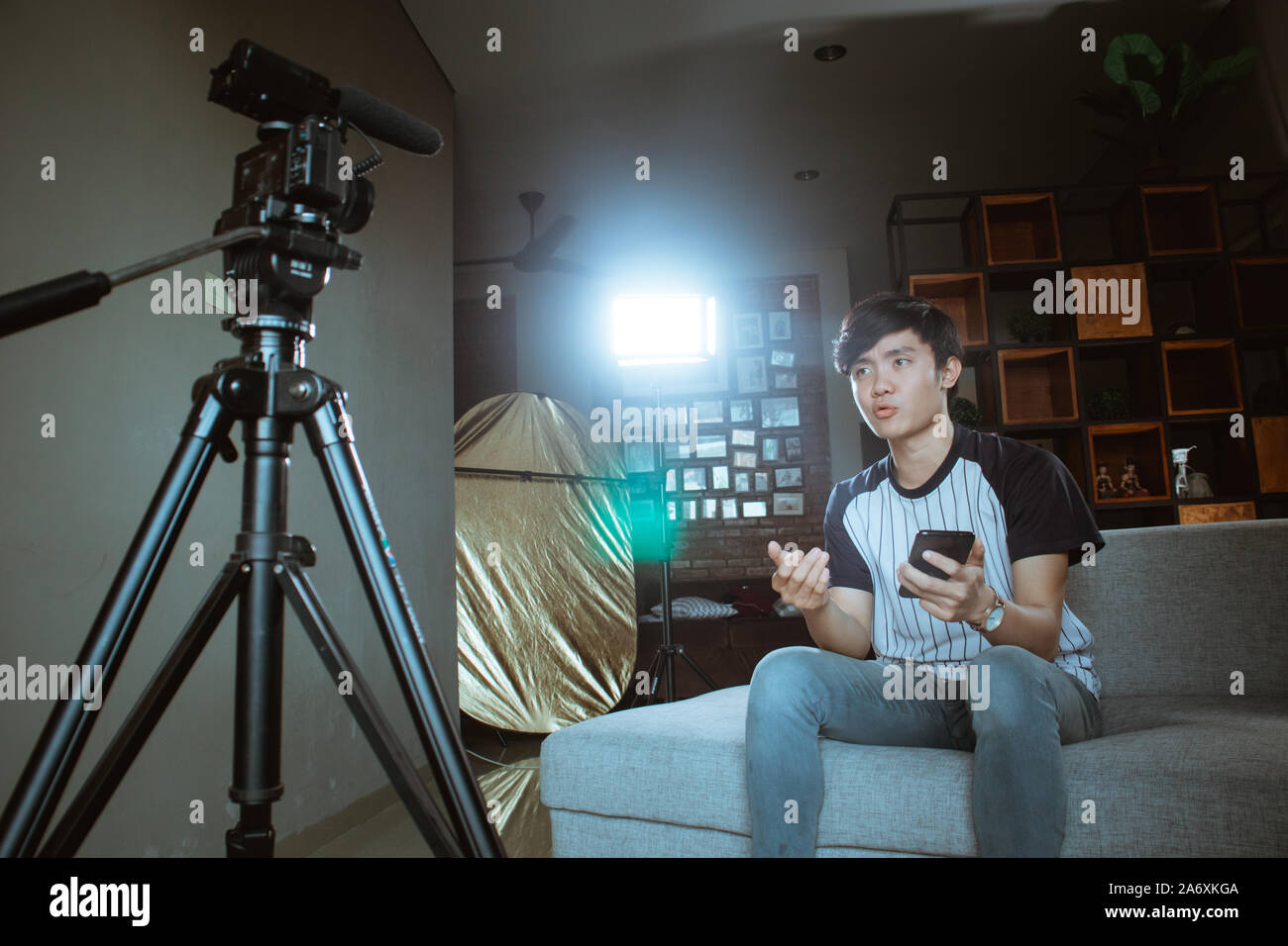 asian young man vlogger make video review about of new type smartphone ...