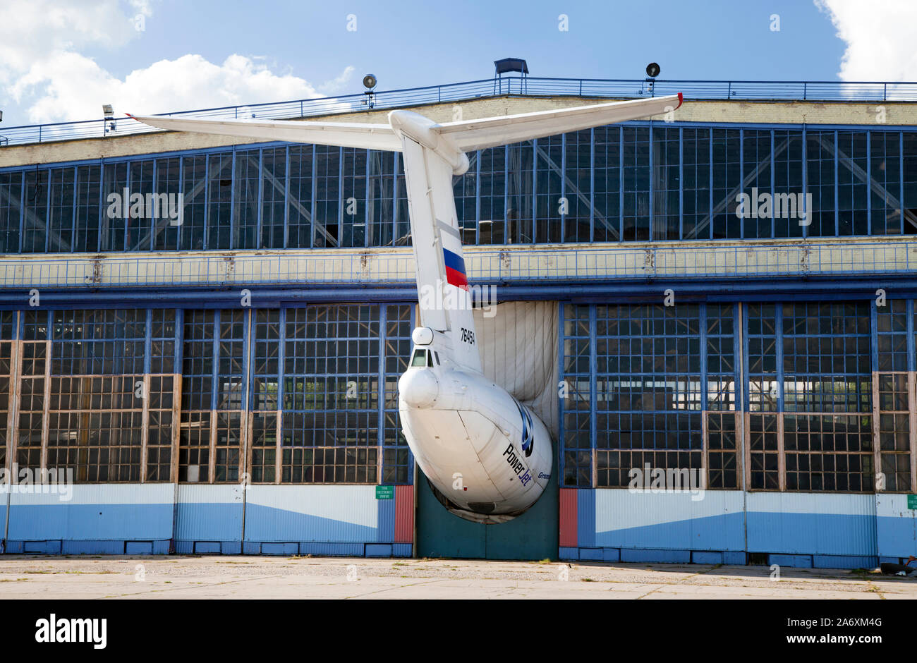 The tail of the Ilyushin IL-76LL aircraft sticking out of the aviation hangar of Zhukovsky ...