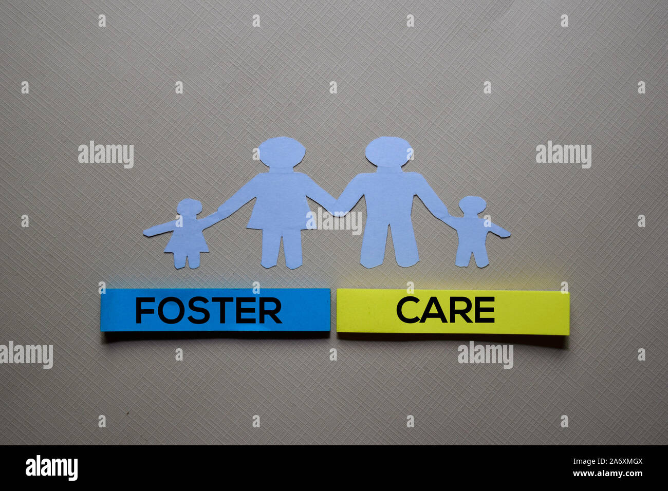 Foster Care text on sticky notes with house and family made in paper on ...