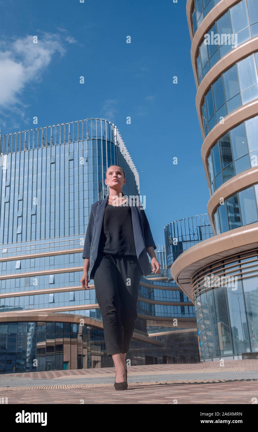 Business woman coming out of building hi-res stock photography and ...