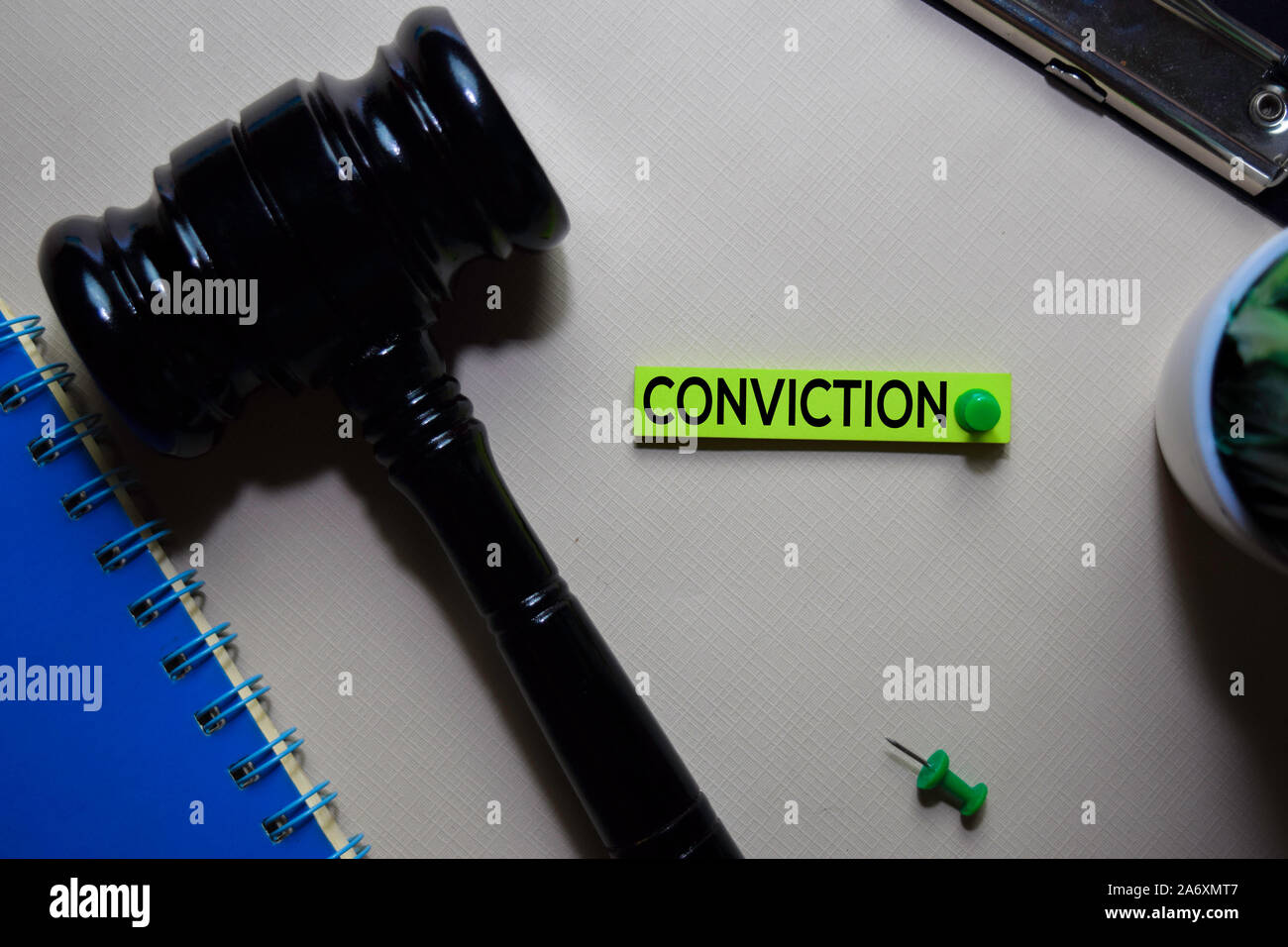 Conviction text on sticky notes and gavel isolated on office desk ...