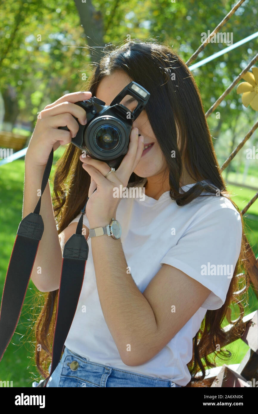 photo with the image of a beautiful young girl with a photo camera ...