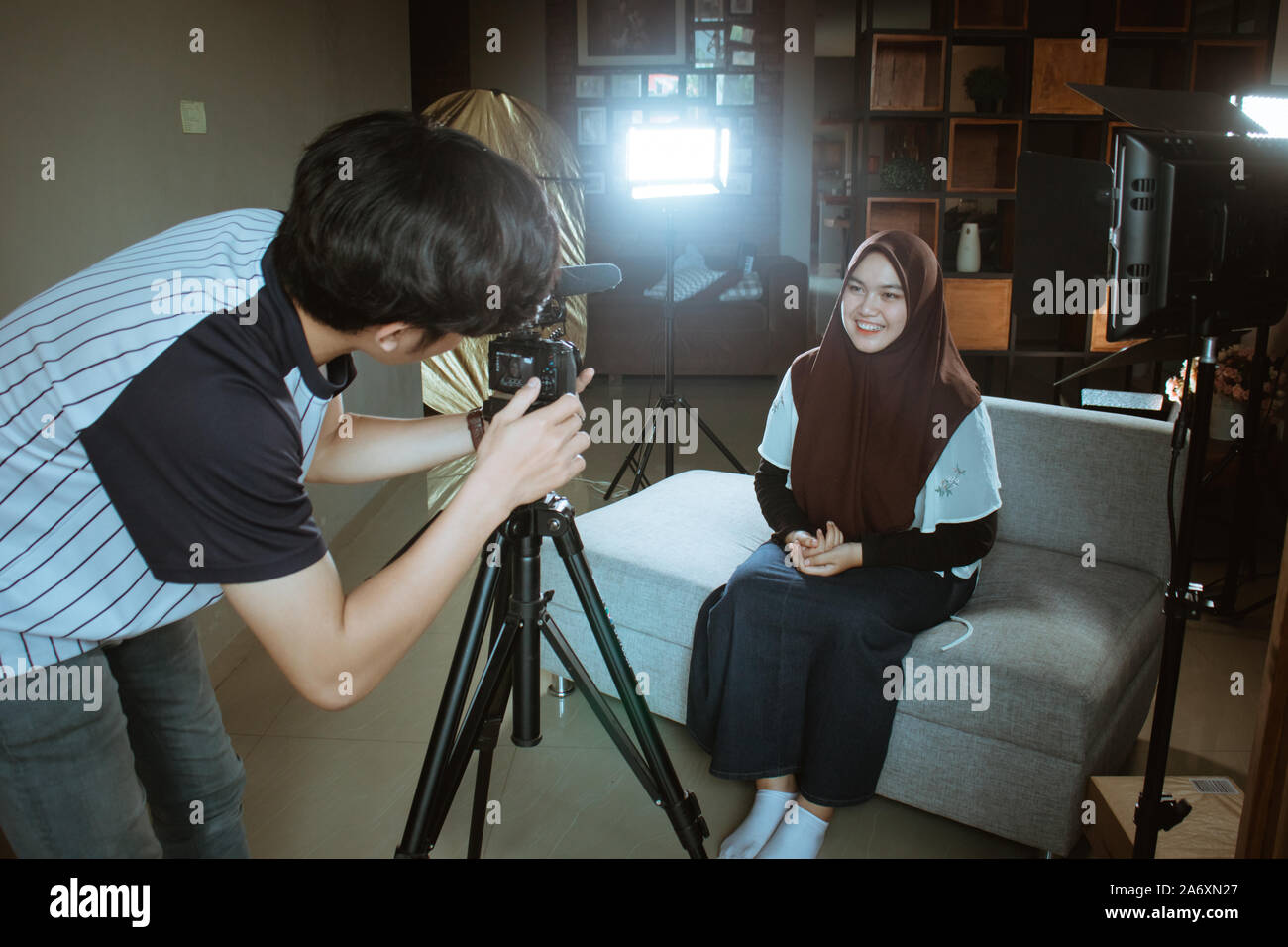 veiled young fashion vlogger sitting in front of camera Stock Photo - Alamy