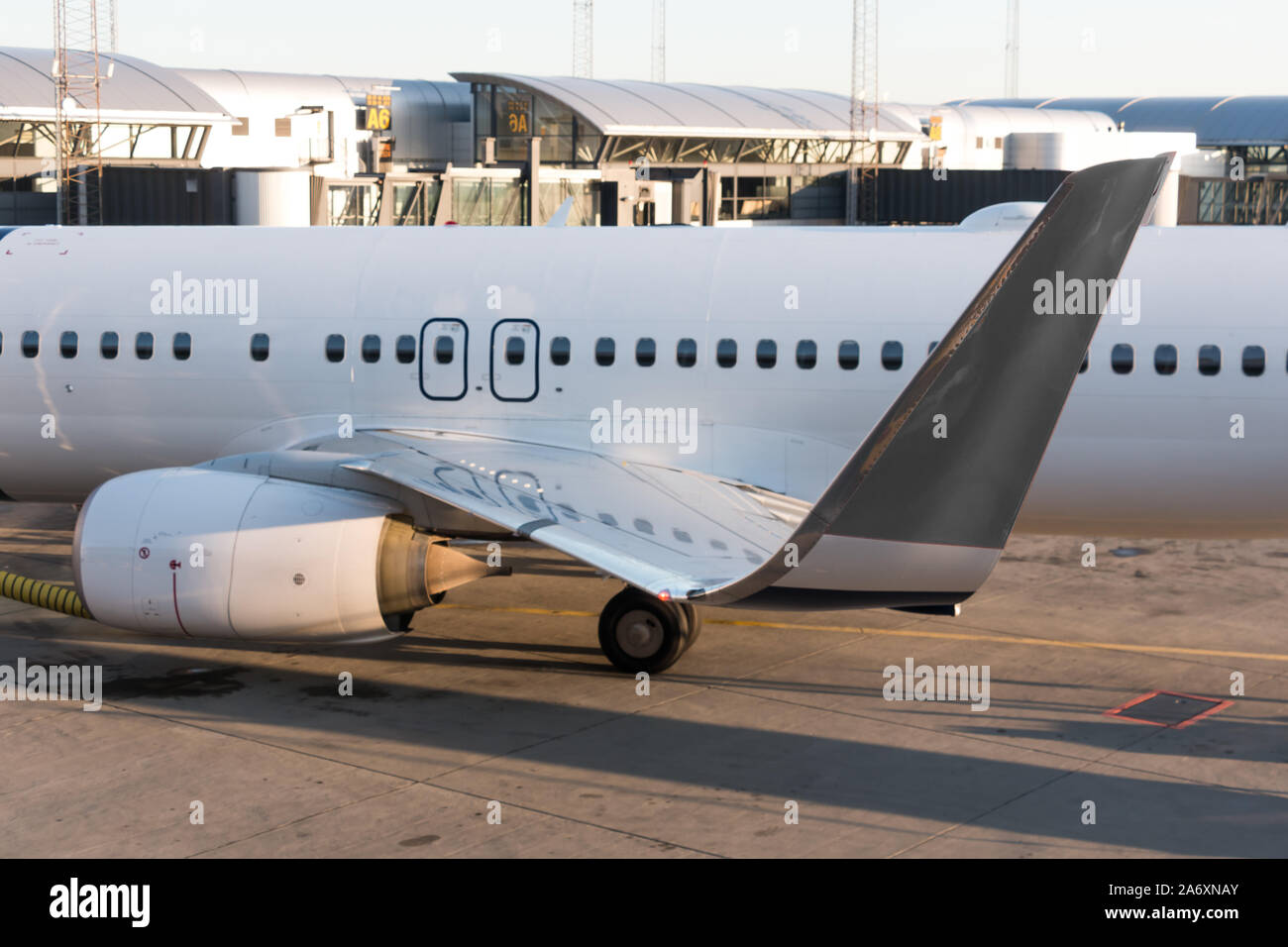 Partial view of the wing and center of the fuselage of a white plane in ...
