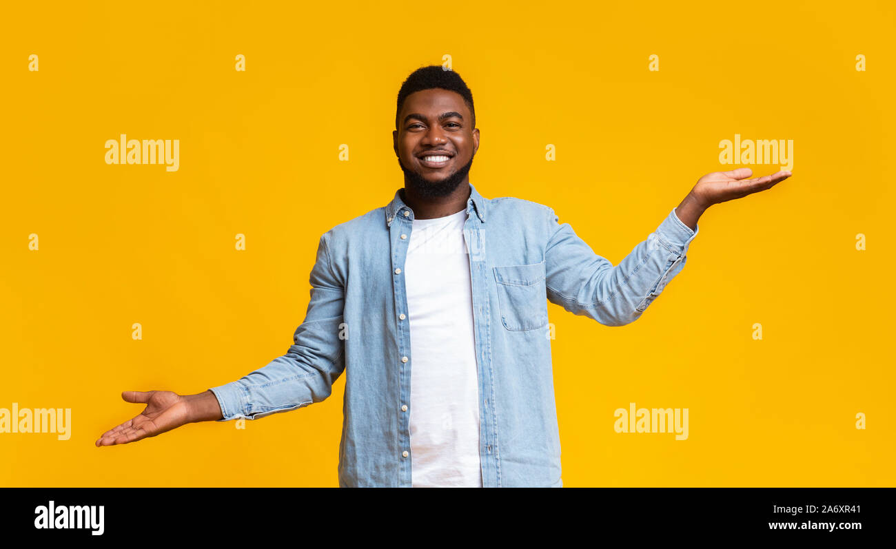 African guy comparing variants, making scales with his empty hands ...
