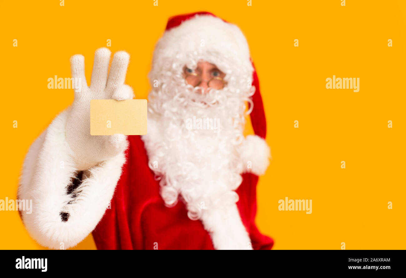 Blurred Santa Claus holding small yellow card with empty space Stock ...