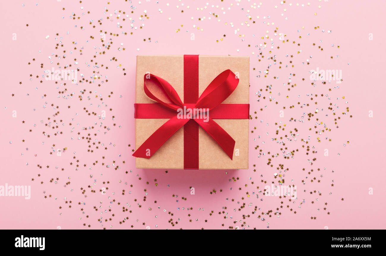 Cute present with red decorative ribbon on pink background Stock Photo ...