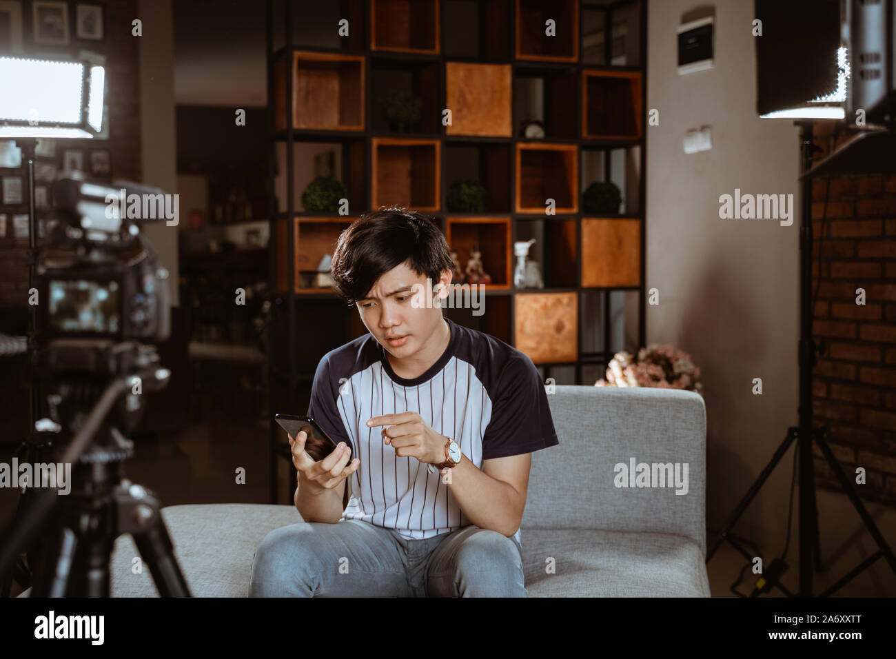 asian young man vlogger make video review about of new type smartphone ...