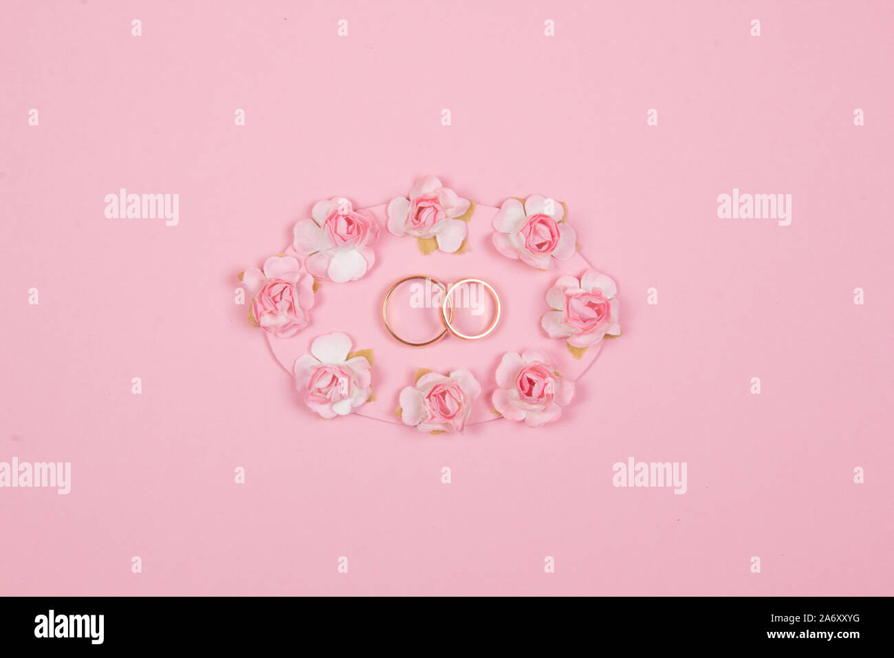 Pink greeting card with gold wedding rings Stock Photo - Alamy