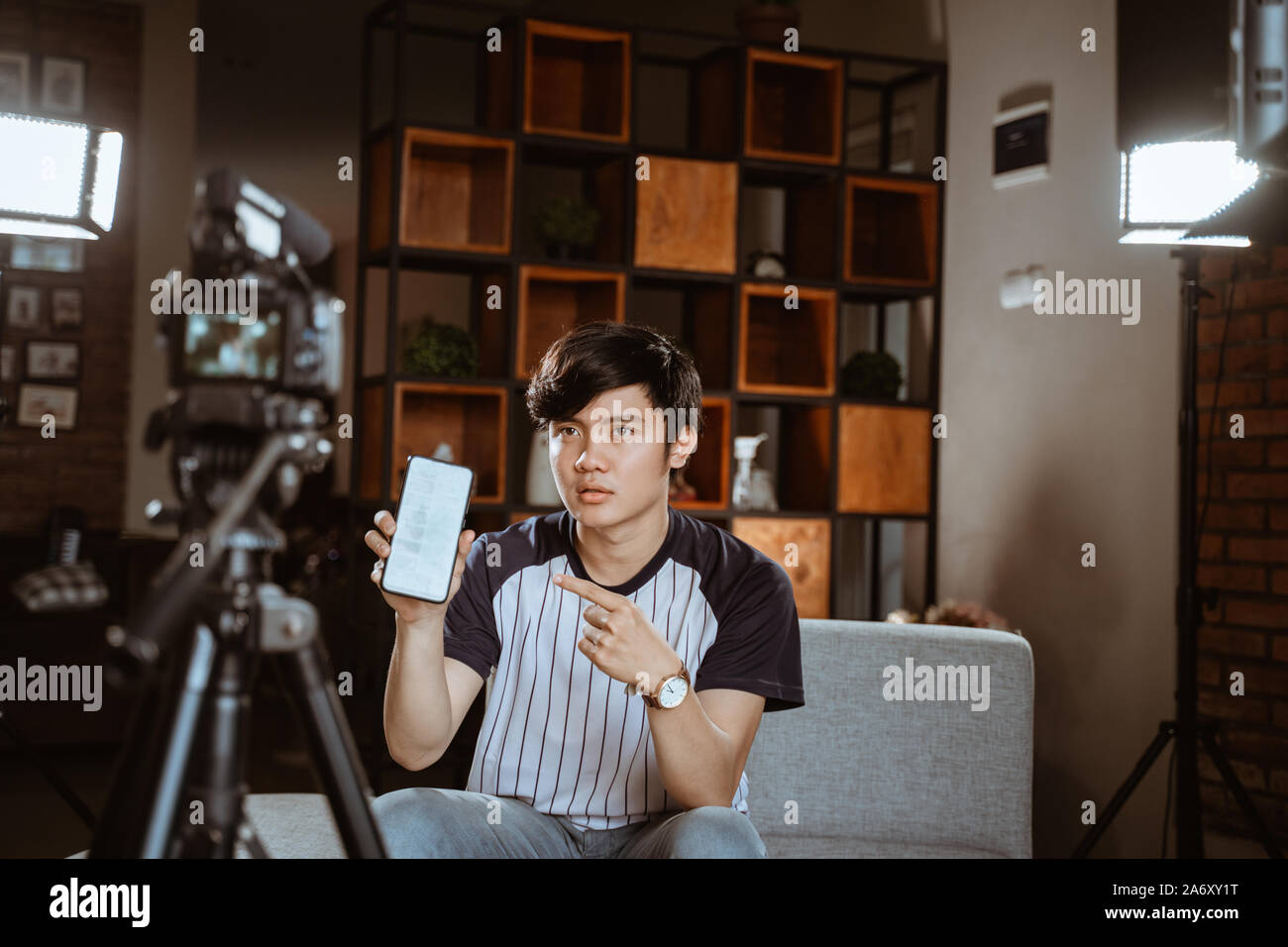 young man vlogger make video review about of new type smartphone series ...