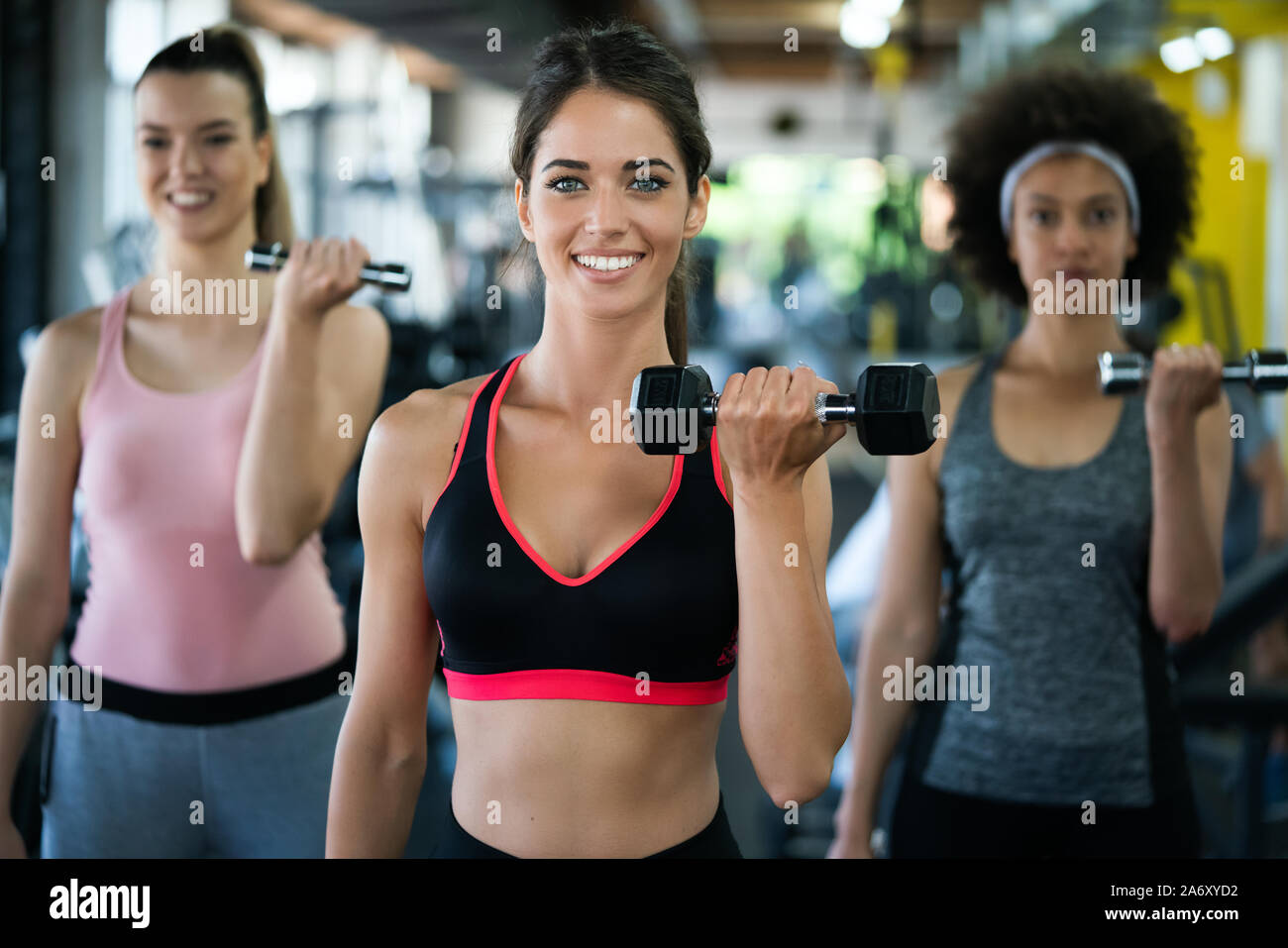 Beautiful fit people exercising together in gym Stock Photo - Alamy
