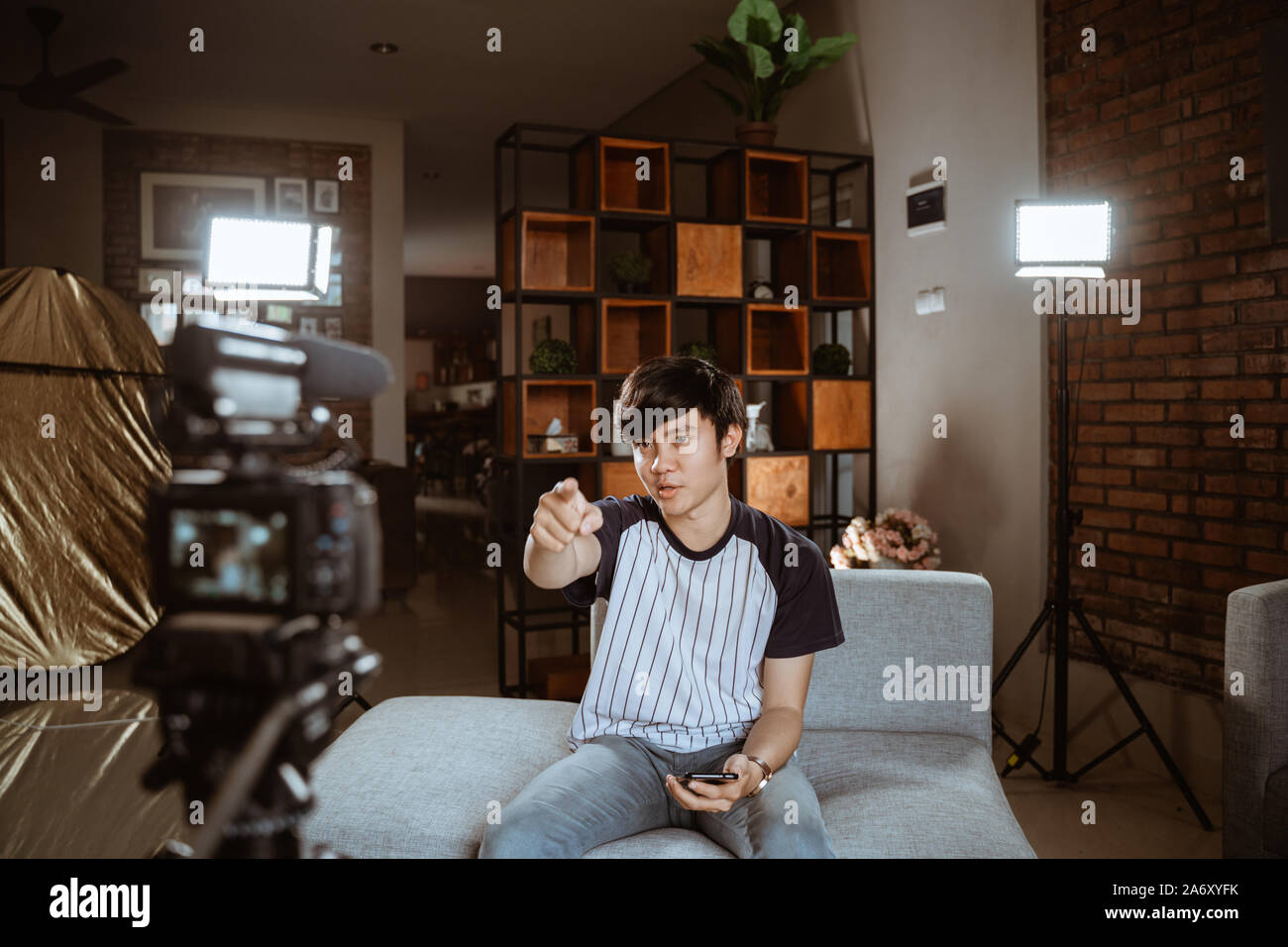 young man vlogger make video review about of new type smartphone series ...