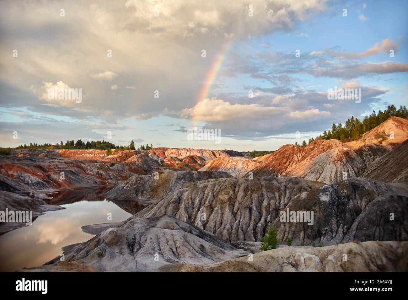 Sunset with a rainbow in the sand hills. Fairytale magical landscape ...