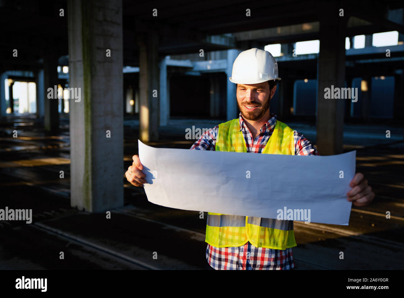 Architect, engineer looking at blueprints in a construction site Stock ...