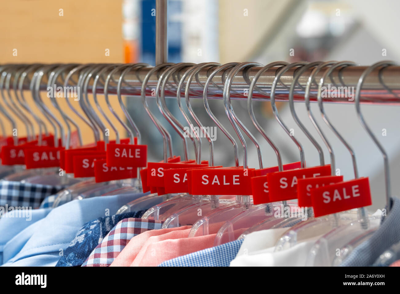 hangers with advertising about sales in store Stock Photo - Alamy