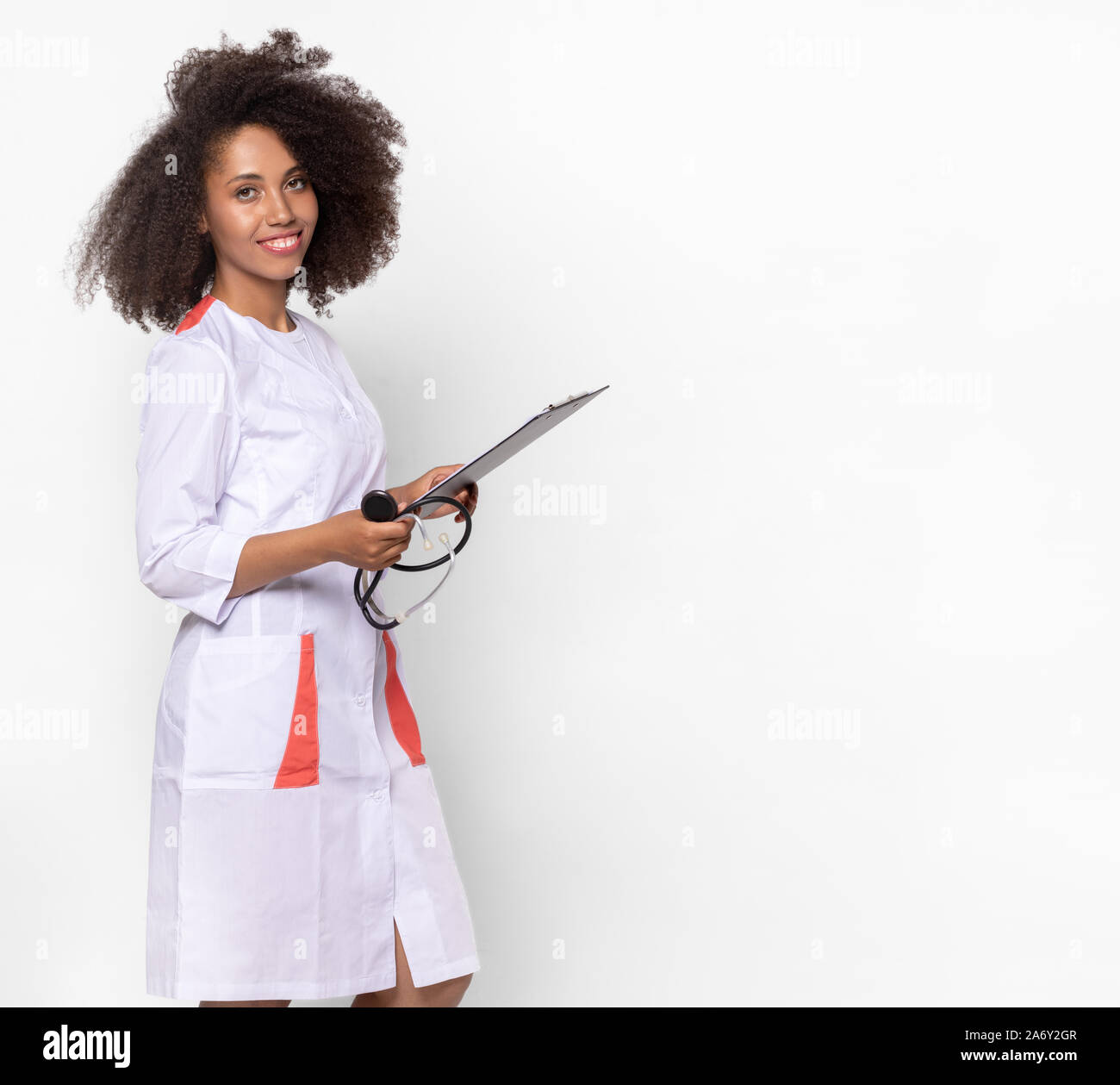 lady doctor in a medic uniform on white wall Stock Photo - Alamy