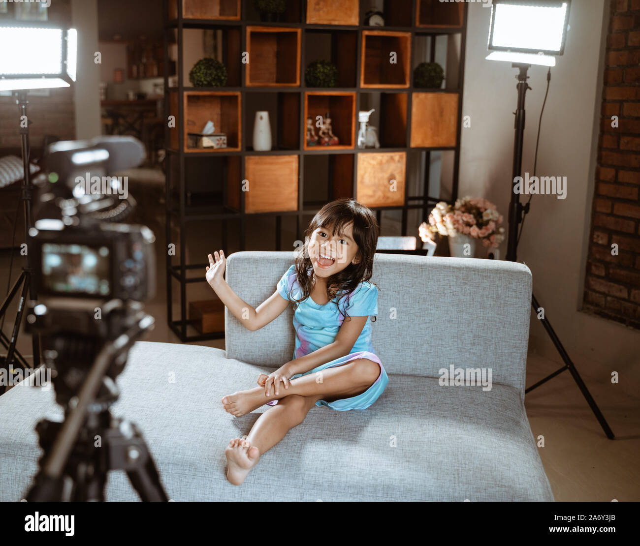 asian little girl blogger make review using the camera on foreground ...