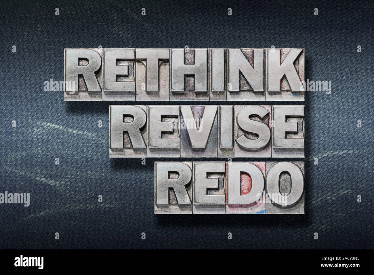 rethink, revise, redo words made from metallic letterpress on dark ...