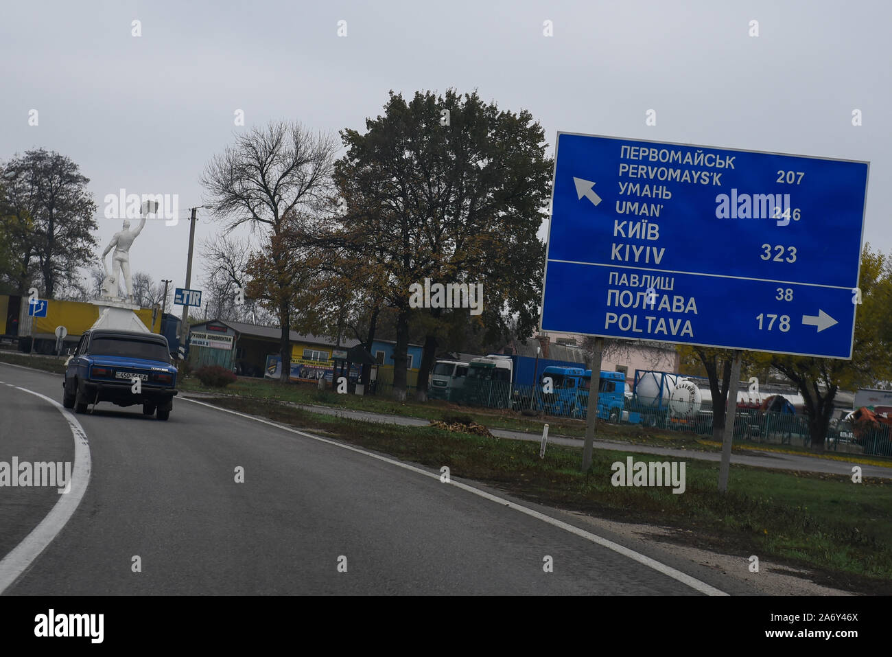 An information plate with directions is seen on the side of the road ...