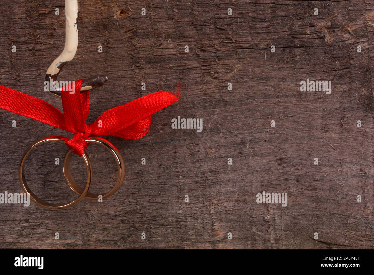 Two wedding rings hanging on a hook Stock Photo - Alamy