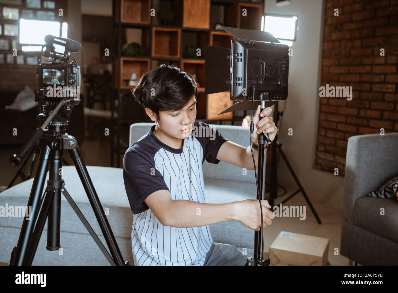 asian young man vlogger preparing lighting to create their vlog Stock ...