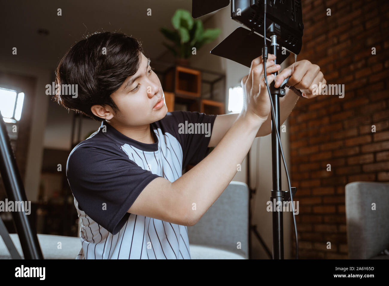 young man vlogger preparing lighting to create their vlog Stock Photo ...