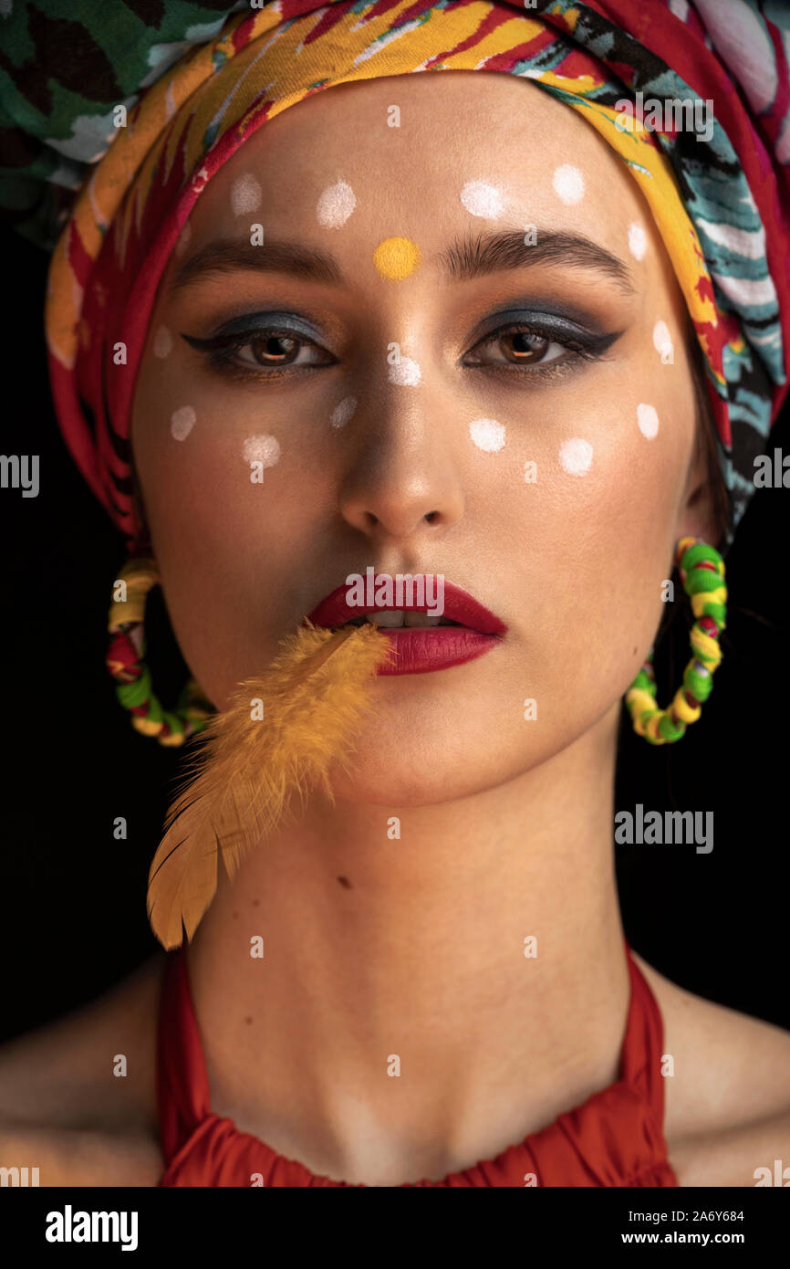 beauty with a bird feather on her lips Stock Photo - Alamy