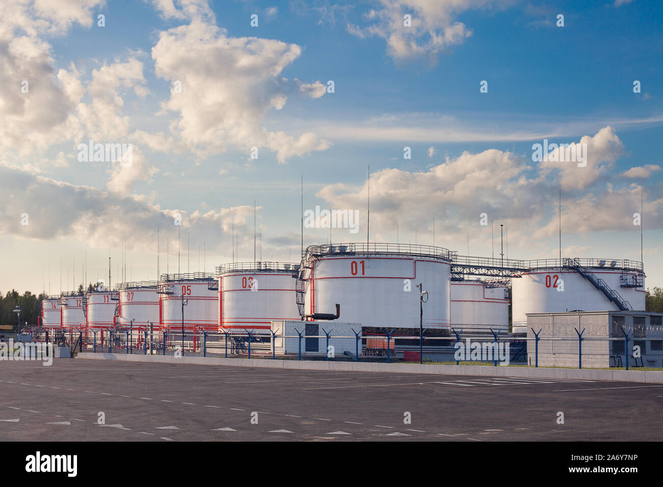 Oil storage tanks terminal on a summer day. Several large barrels of ...