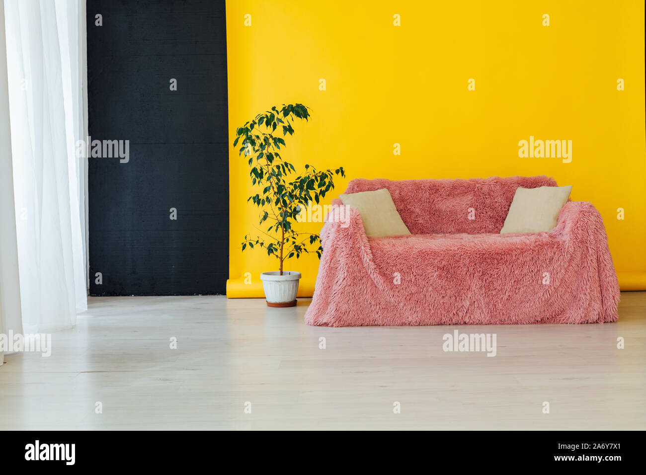 pink sofa in the interior of the room with a yellow background Stock ...