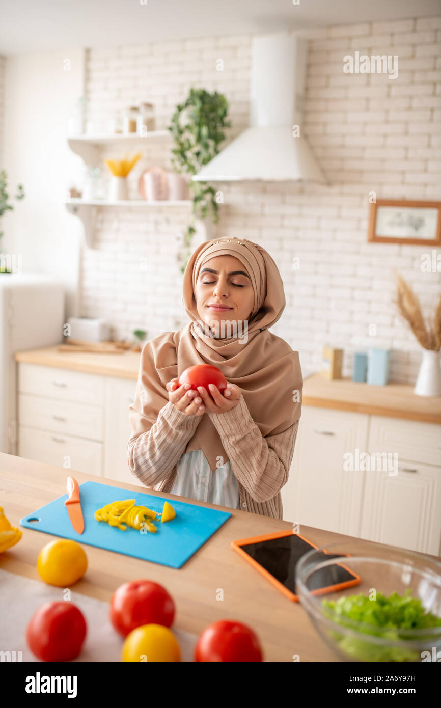 Pretty woman enjoying the smell of vegetables Stock Photo - Alamy