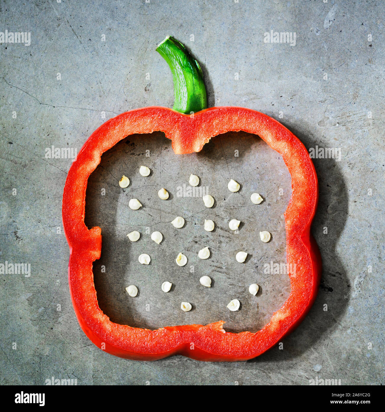 Red pepper creatively sliced and setup with seeds and stem on a ...