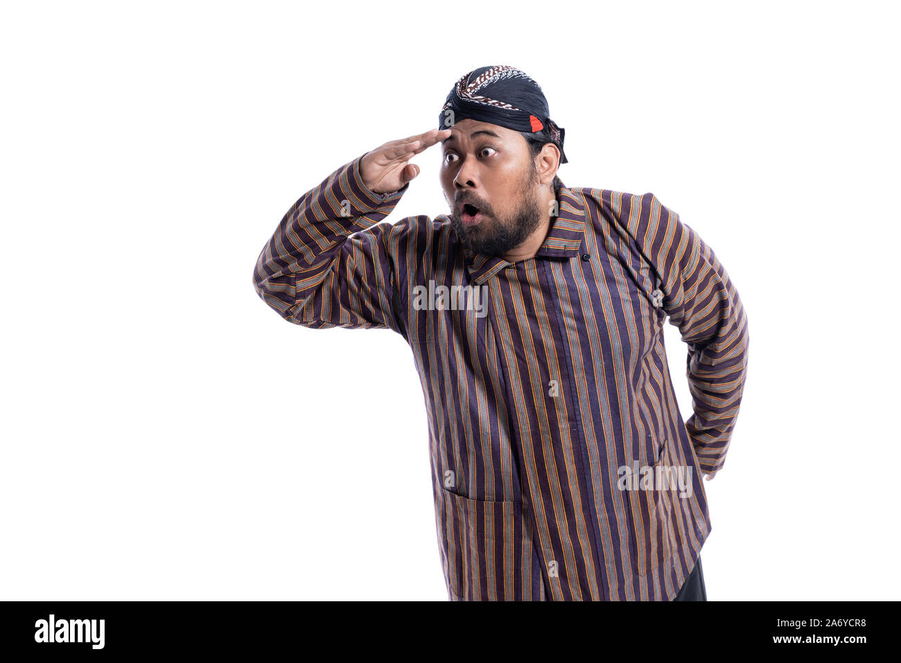 man with javanese traditional cloth lurik looking up for something ...