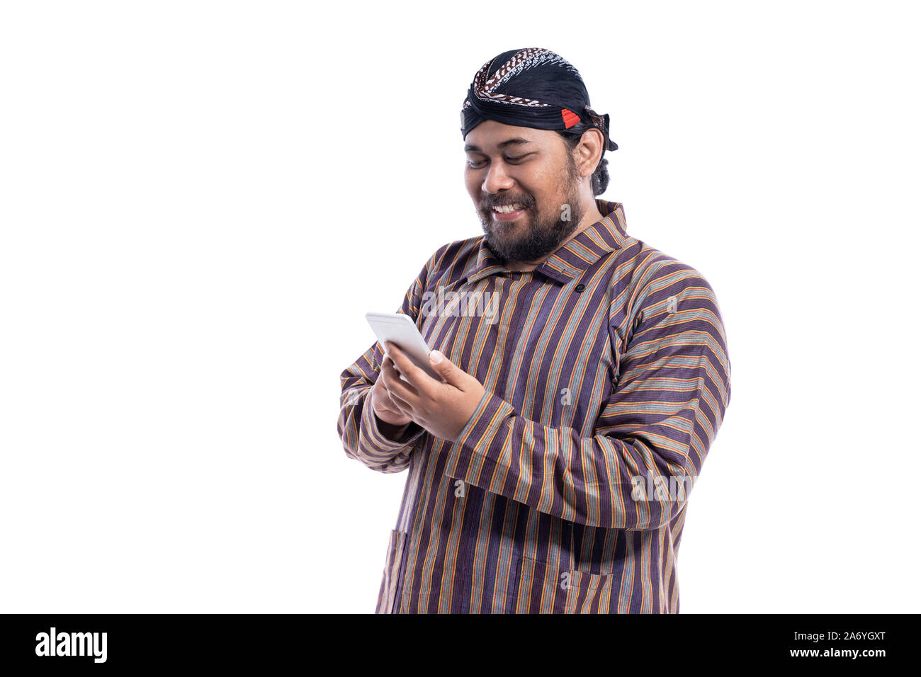 male with javanese traditional cloth lurik using smartphone Stock Photo ...