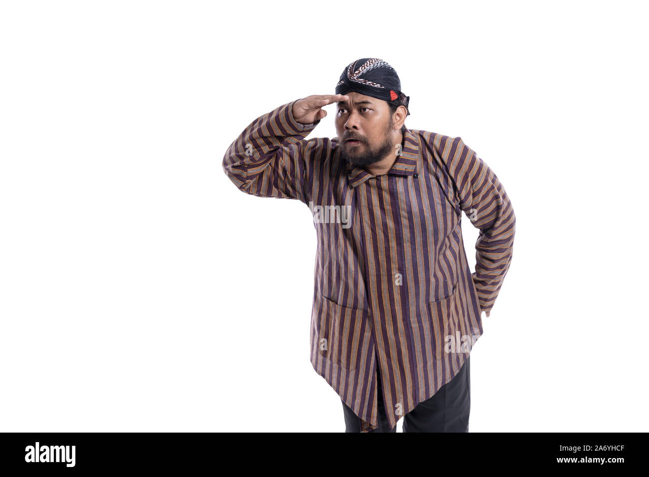 man with javanese traditional cloth lurik looking up for something ...