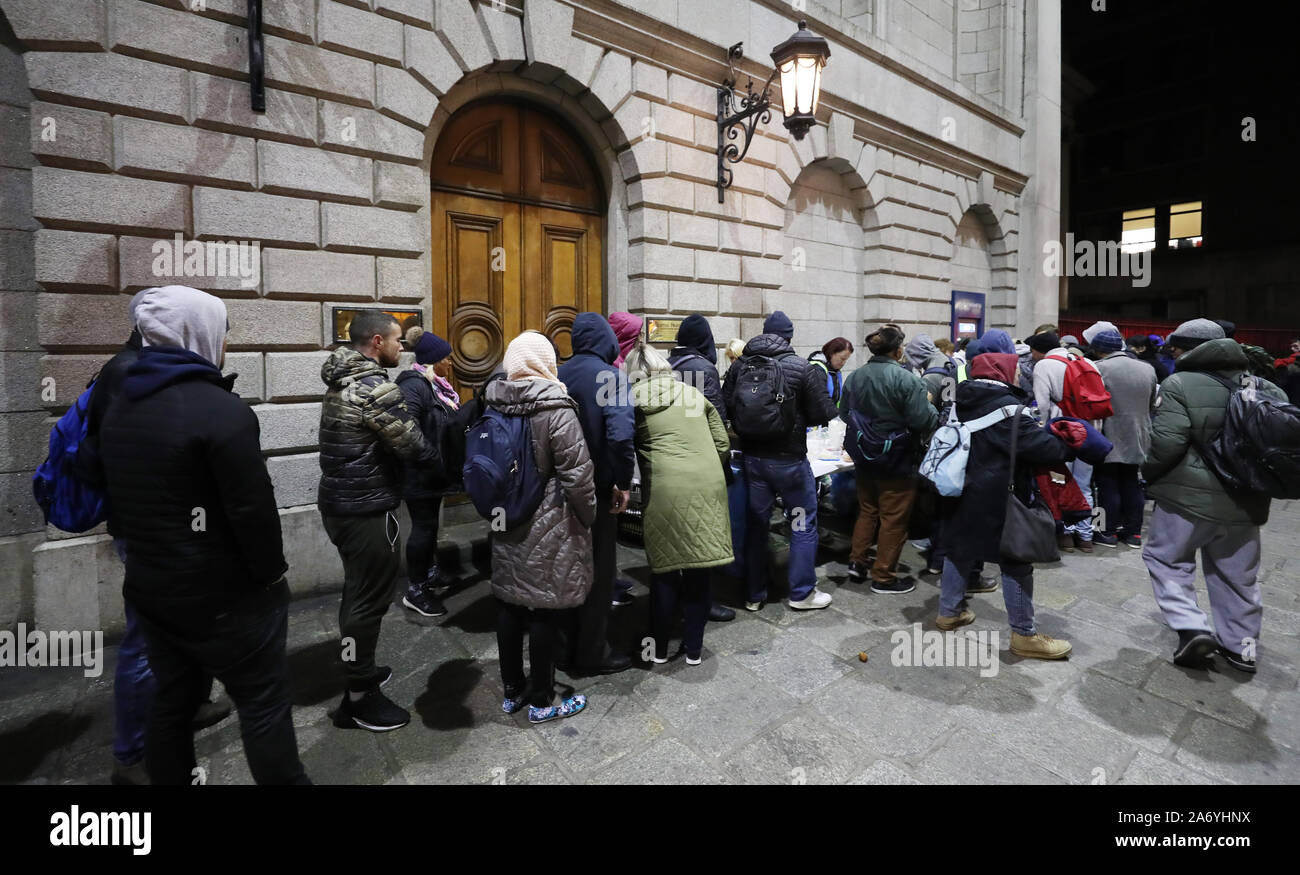 People queue up for hot food at The Lending Hand, a soup kitchen ...