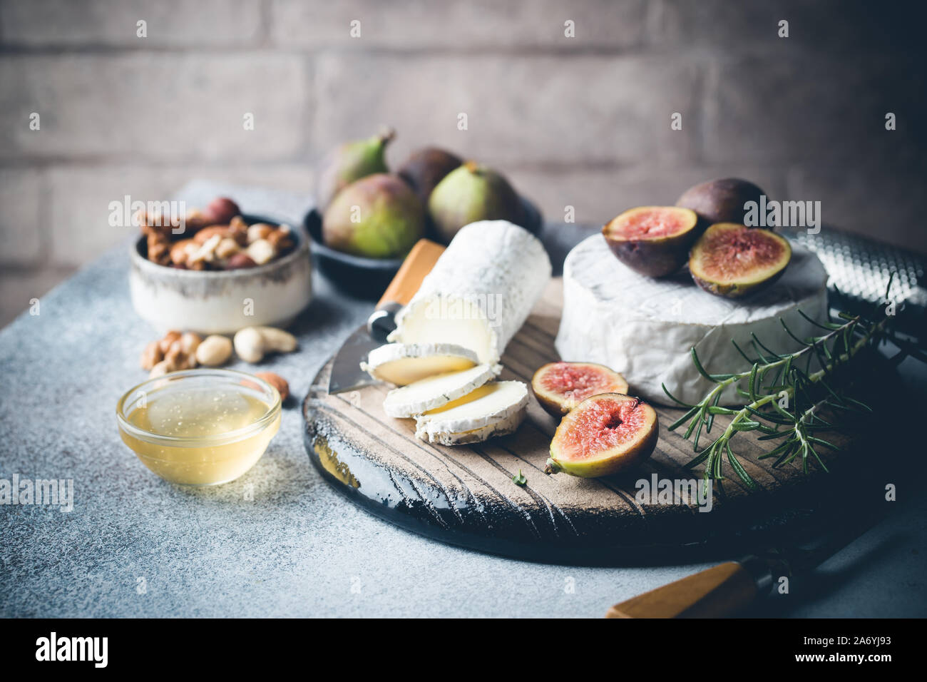 Fresh goat brie cheese with truffle and white mold on cheese platter ...