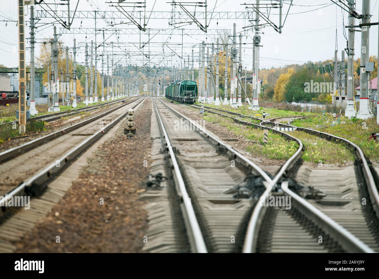 freight train at the station with rails and arrows Stock Photo - Alamy