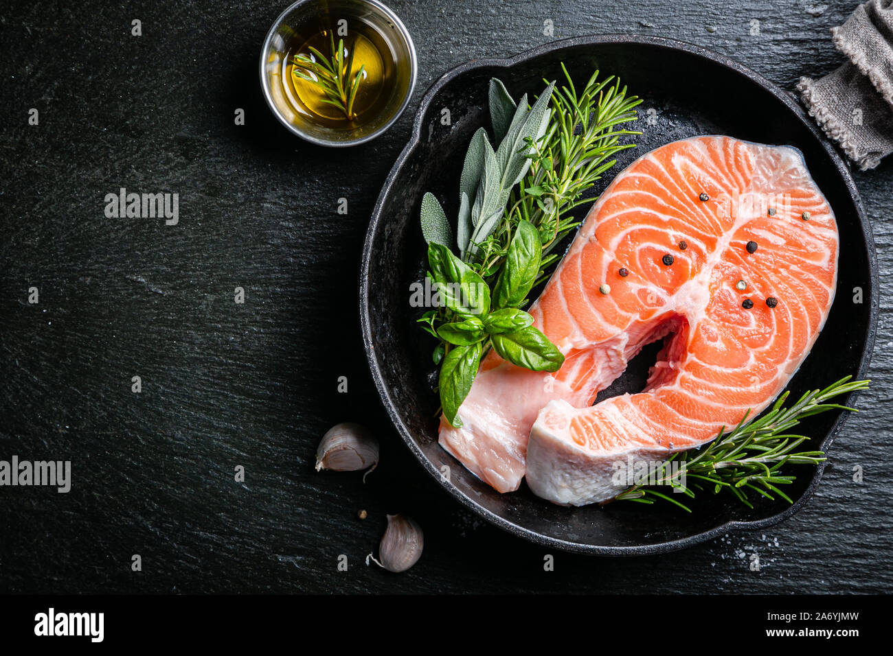 Raw salmon with herbs and spices, rustic background Stock Photo - Alamy