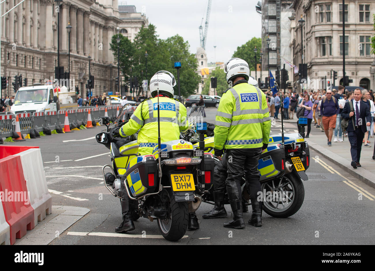 Police motorcycle officers at a road block on street leading to ...