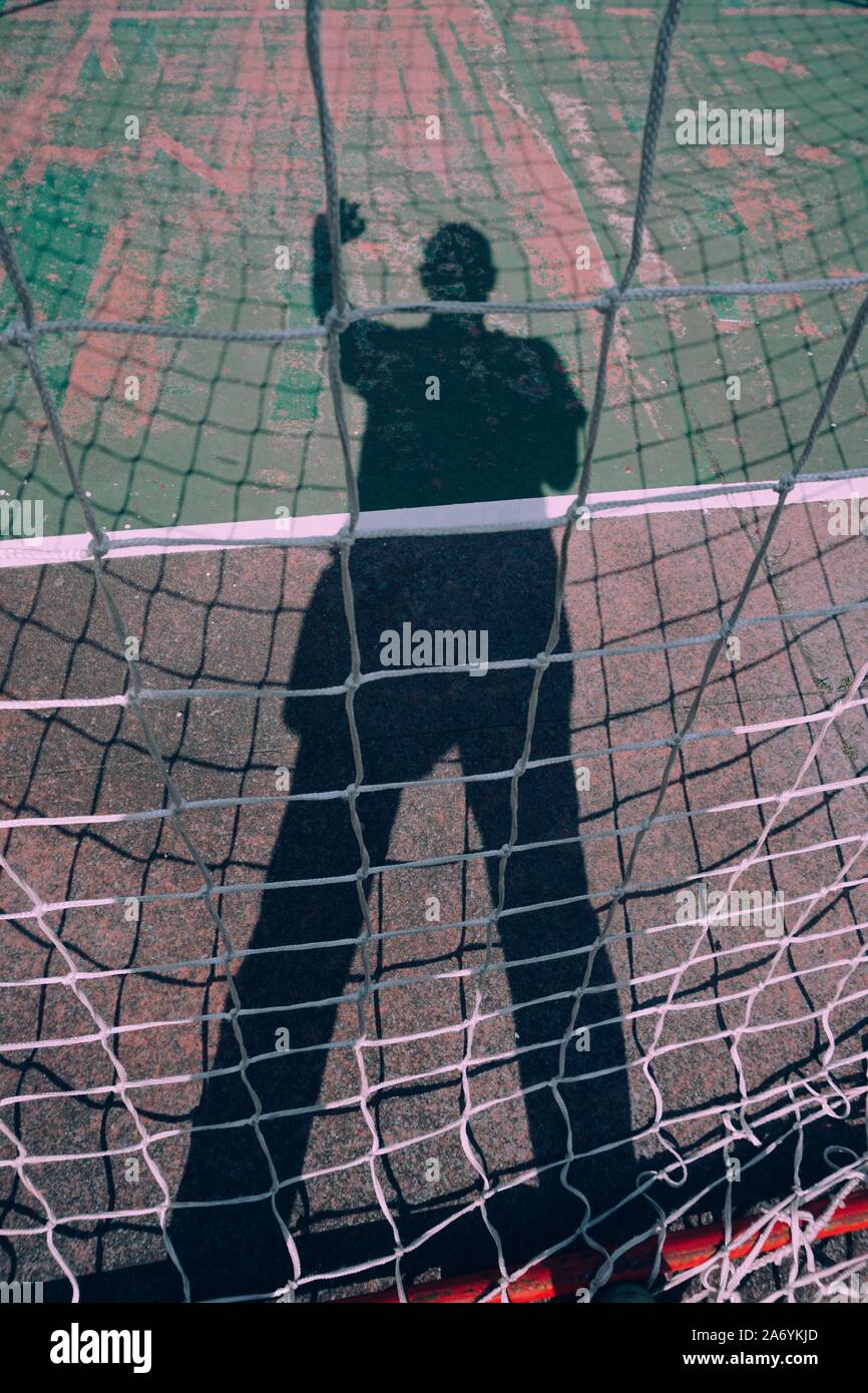 man shadow silhouette on the soccer field on the street Stock Photo - Alamy