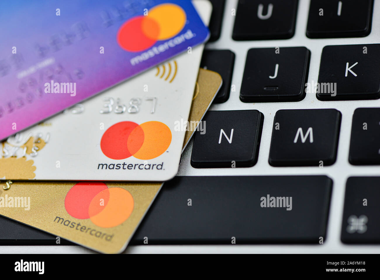 Three credit cards on a computer keyboard - image Stock Photo - Alamy