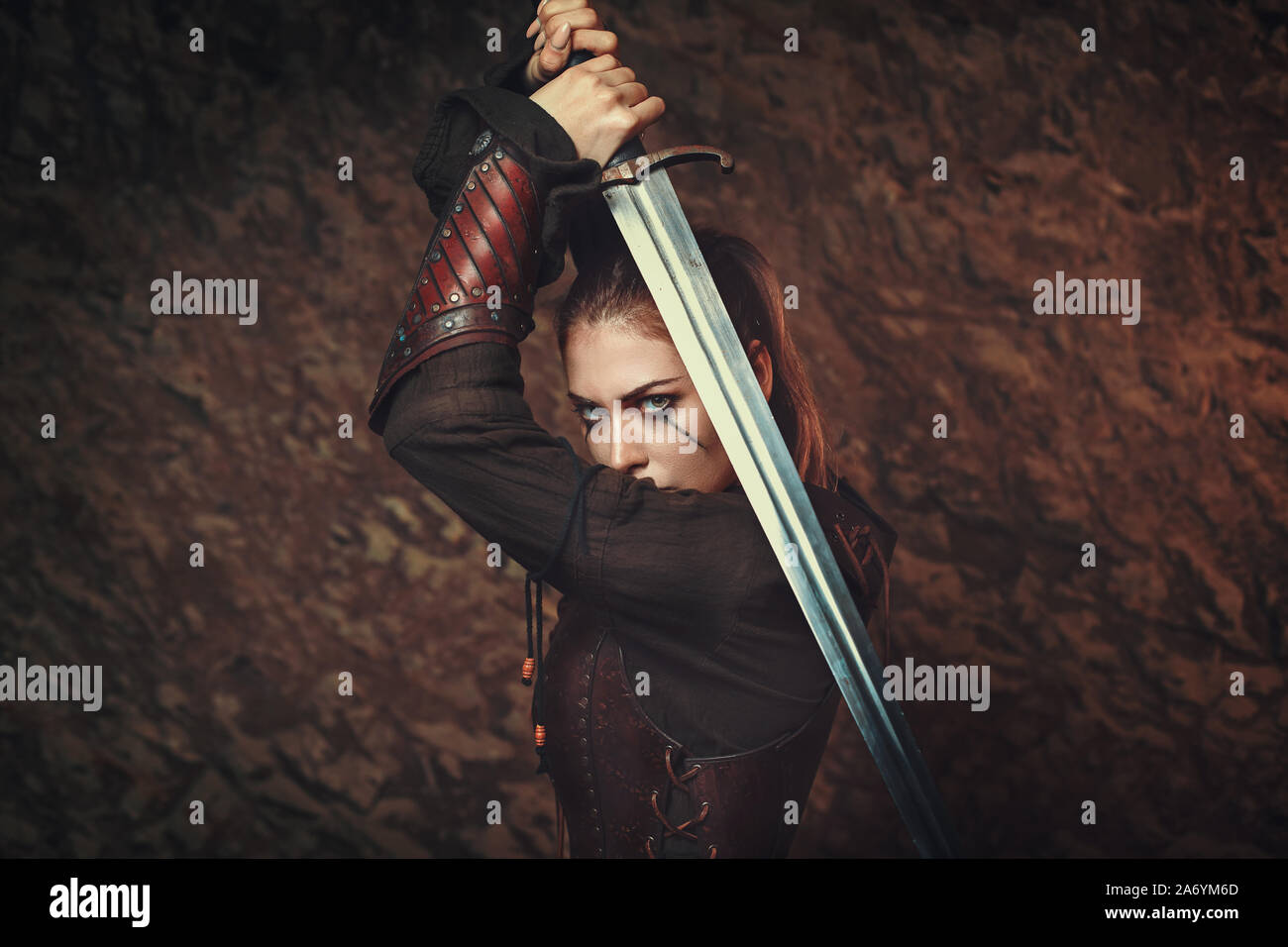 Fighter woman in parrying position with sword Stock Photo - Alamy