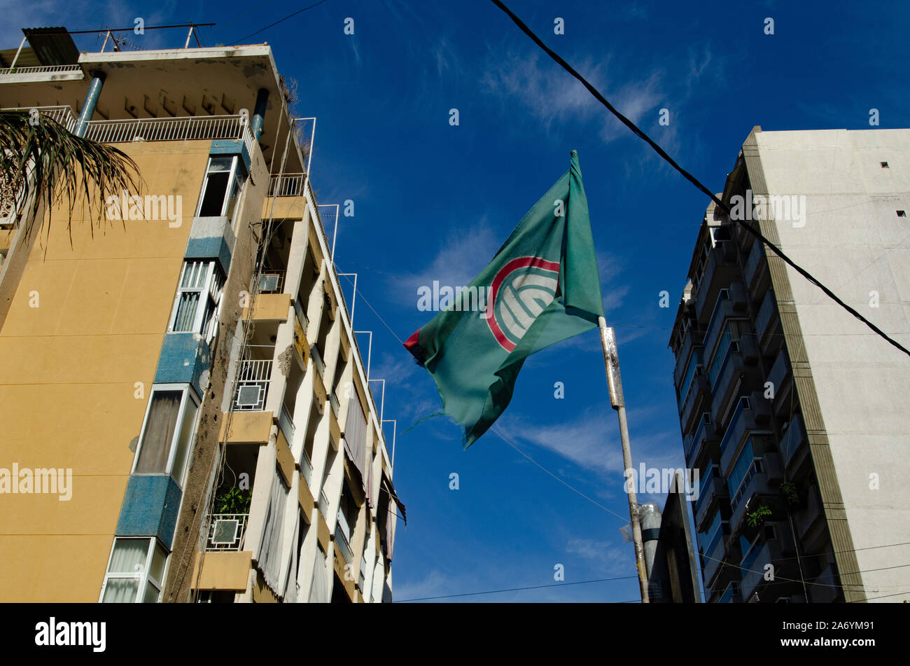 The flag of the Shia dominated Amal Movement fluttering in a downtown ...