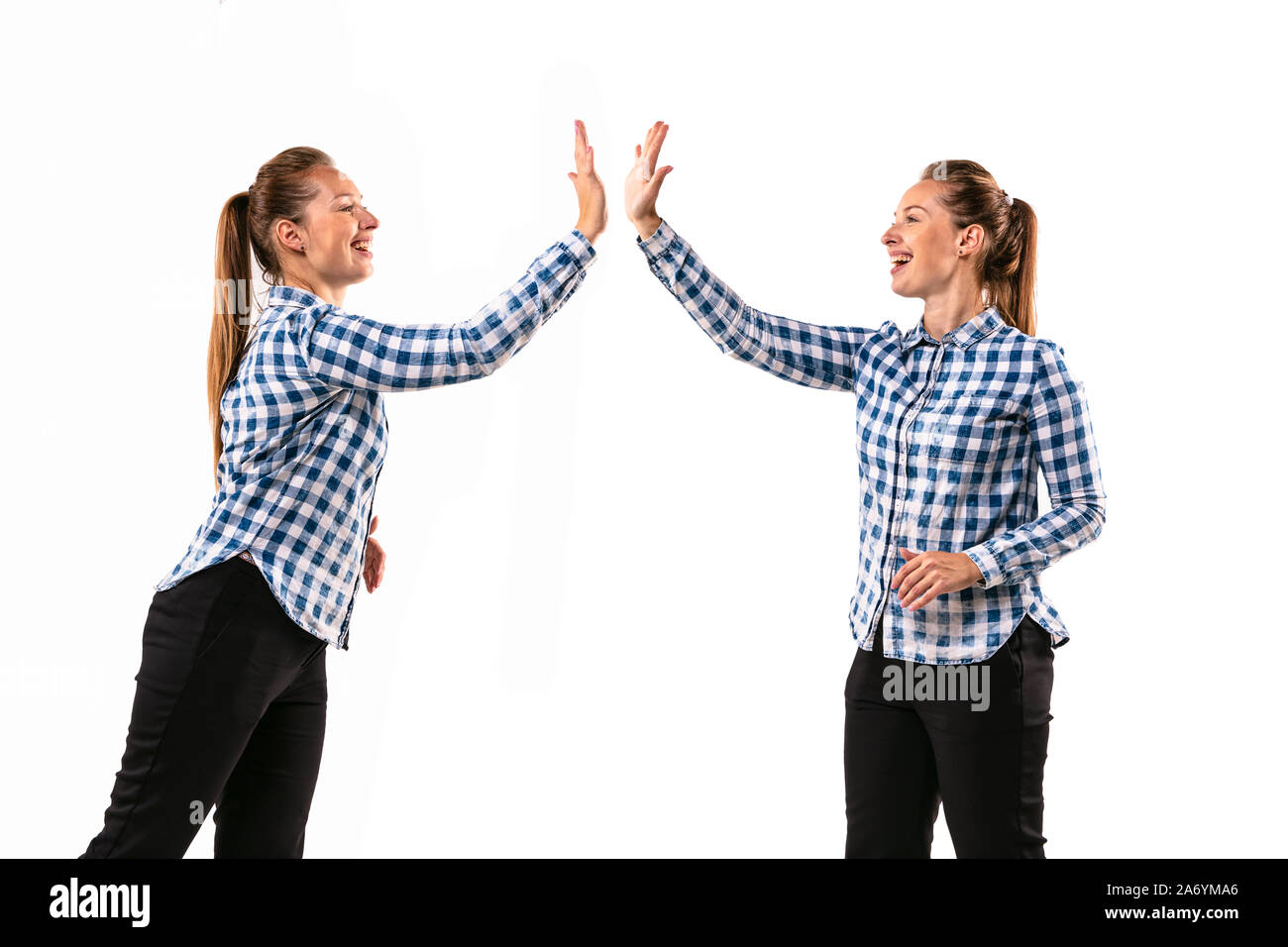 Young handsome woman agrees with herself on white studio background ...