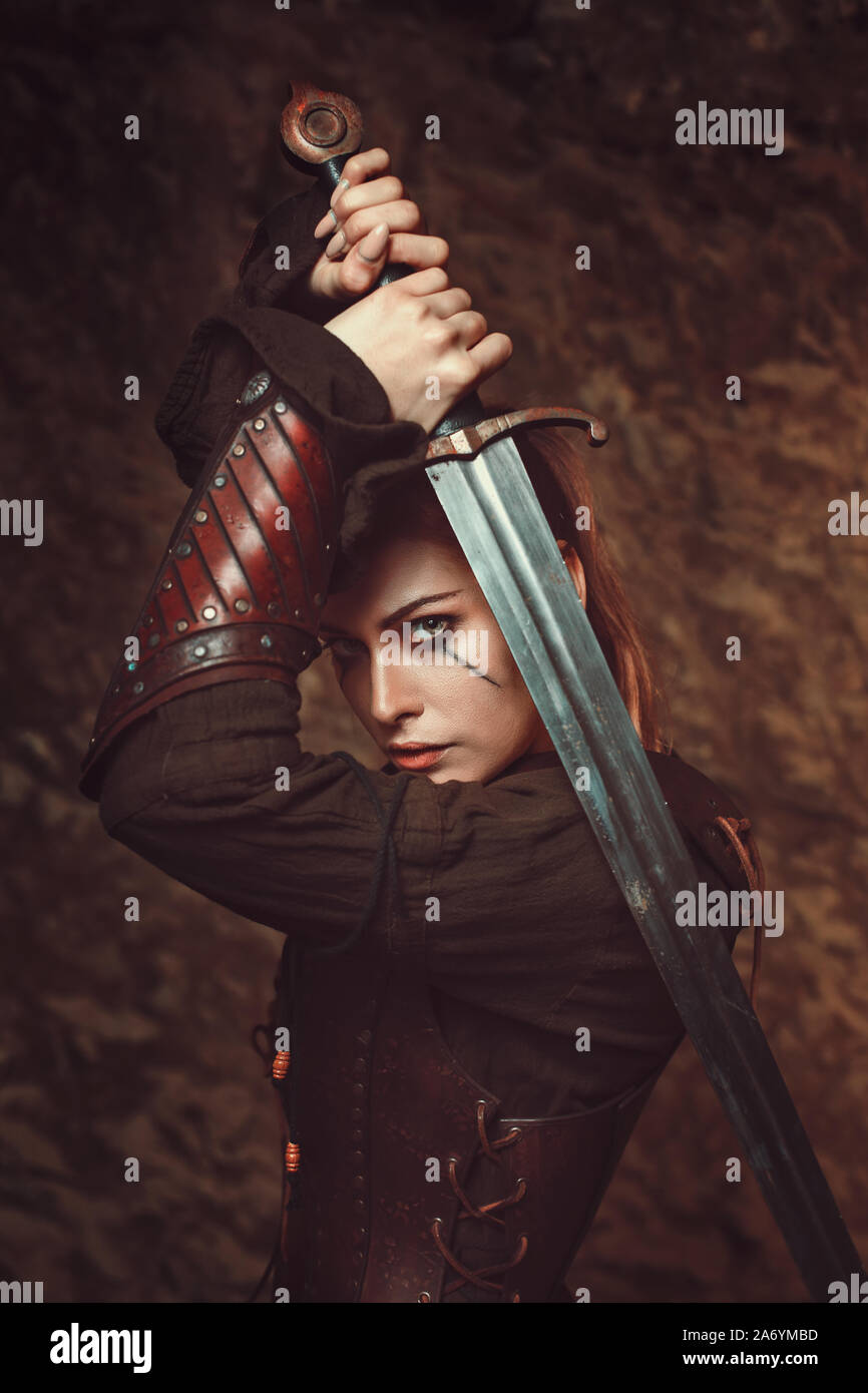 Beautiful woman fighting with sword Stock Photo - Alamy