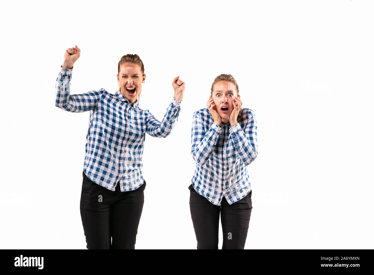Young handsome woman winning with herself on white studio background ...