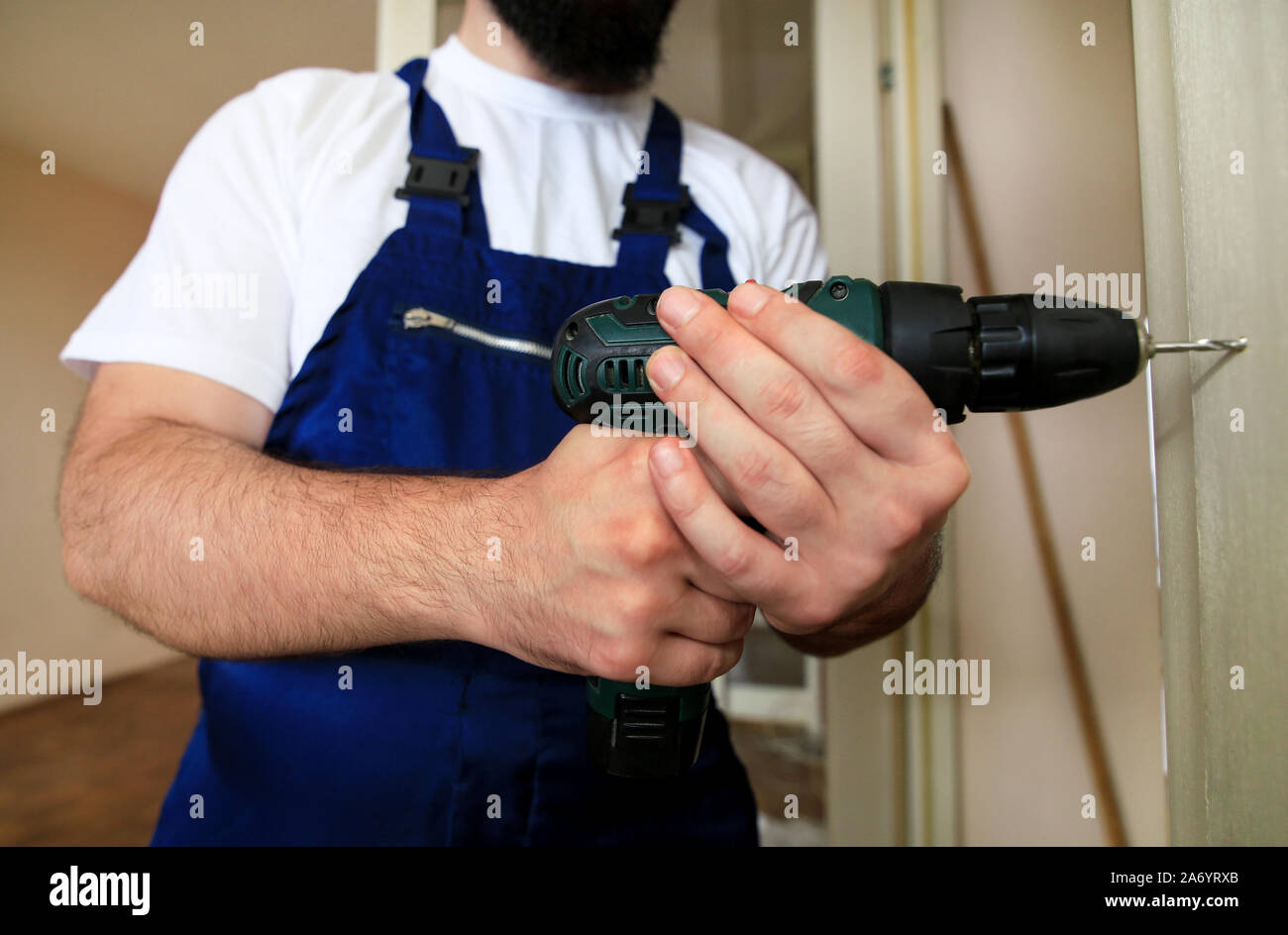 Construction worker and handyman works on renovation of apartment ...