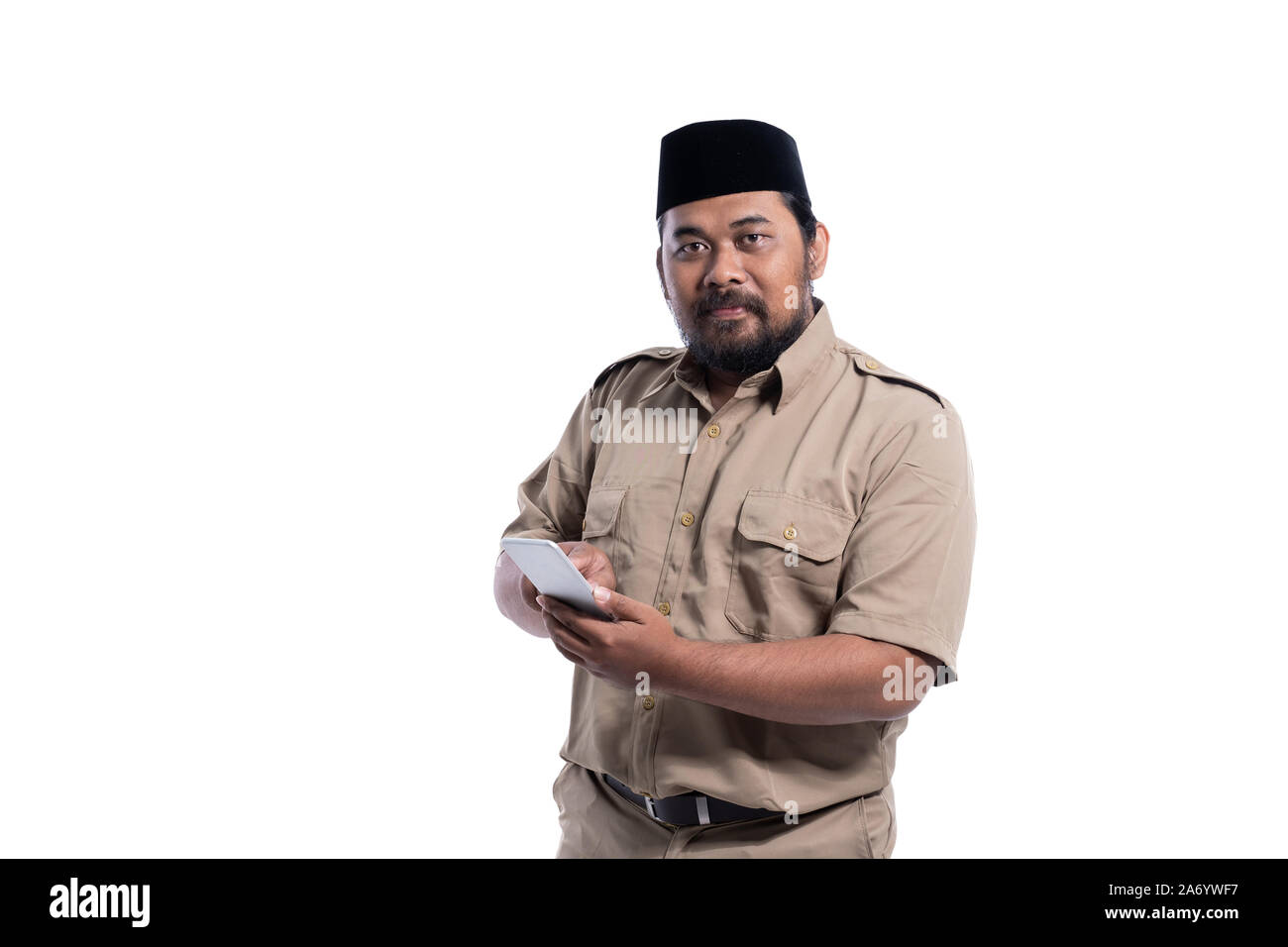worker with brown uniform indonesia smiling using phone Stock Photo - Alamy
