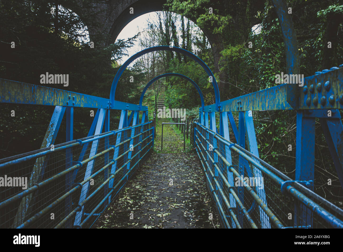 Crossing over a river on a small bridge with archways and steps in the ...