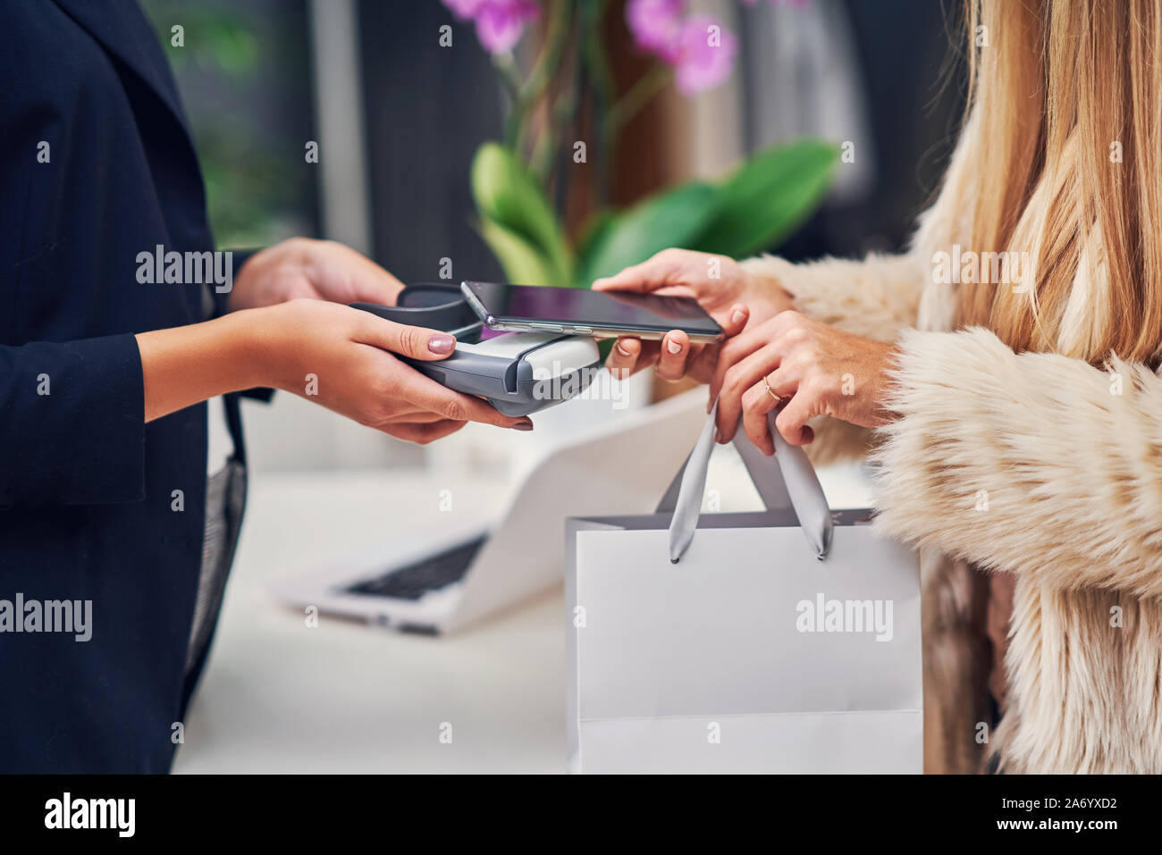Shop assistant serving the customer in store Stock Photo - Alamy